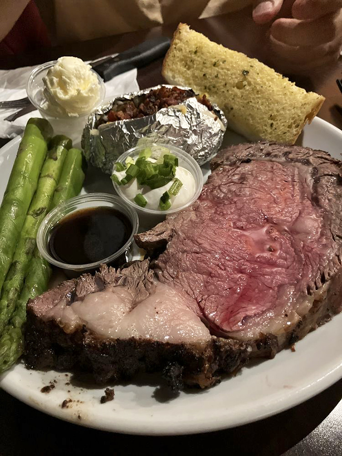 Prime rib so perfectly pink it should be illegal. That au jus is practically begging to be sopped up with garlic bread.