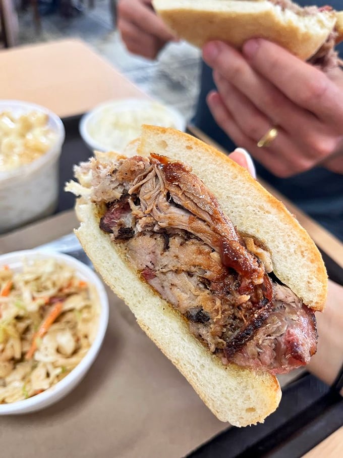 Behold the pulled pork in its natural habitat&mdash;tender strands of smoky perfection nestled between bread that knows its supporting role.