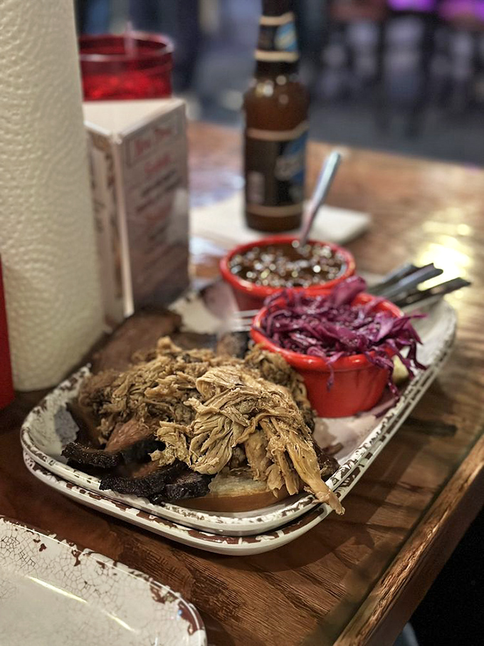 This plate isn't just dinner, it's a smoky masterpiece featuring pulled pork and brisket accompanied by purple slaw and cheesy potatoes.