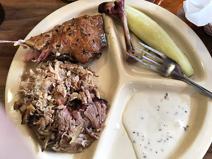 The holy trinity of Alabama barbecue: pulled pork, chicken, and that legendary white sauce. Notice the perfect smoke ring&mdash;nature's way of saying "you're welcome."