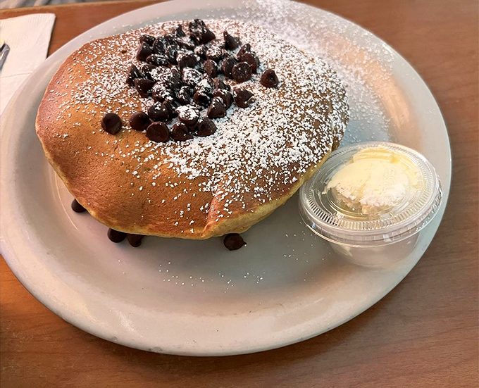 Chocolate chip pancakes dusted with powdered sugar&mdash;proof that sometimes the universe does want you to be happy. Butter on standby.