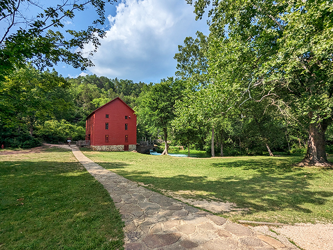 The iconic red mill stands sentinel by the spring, like a cheerful landmark from a time when "processing" meant water power, not computer chips.