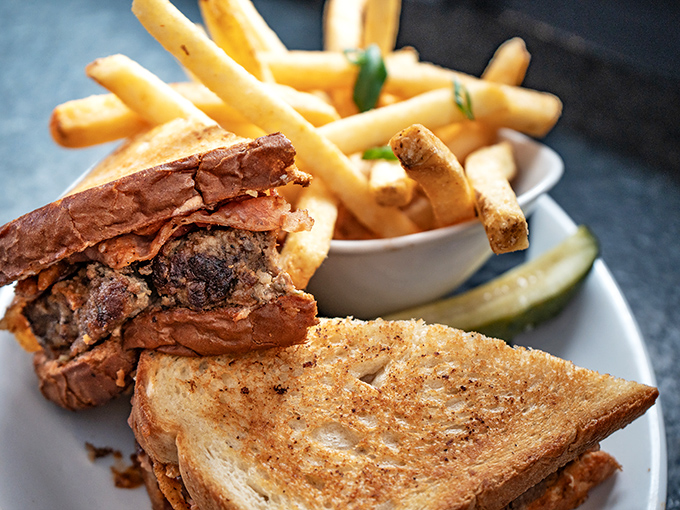 This isn't just a sandwich; it's a masterclass in architecture. Layers of flavor stacked between perfectly toasted bread with fries standing at attention.