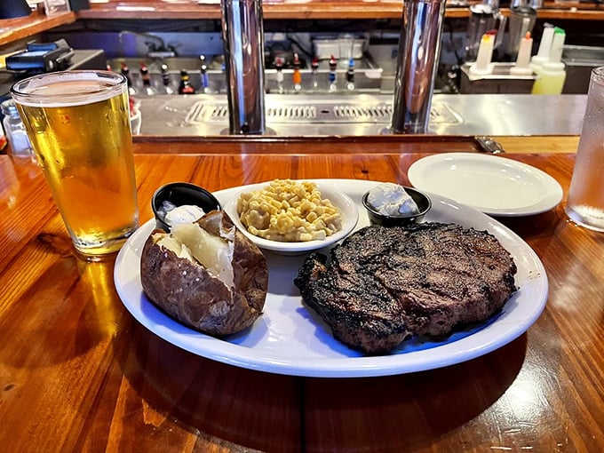 A perfectly seared steak alongside a loaded baked potato and mac & cheese. This isn't just dinner&mdash;it's therapy on a plate.