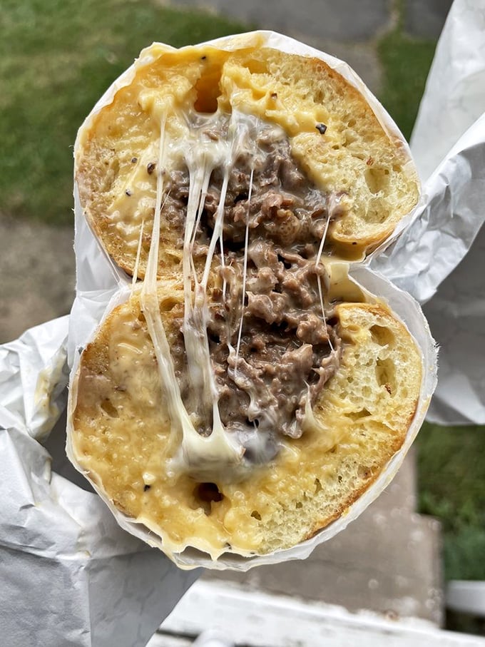 Cheese pulls that could win Olympic medals. This cross-section reveals the beautiful marriage of tender ribeye and molten cheese that haunts dreams.