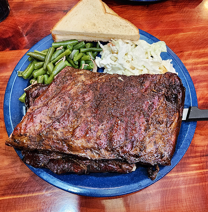 These ribs don't need fancy introductions—their dark, caramelized bark and pink smoke ring speak volumes about the patience that created them.
