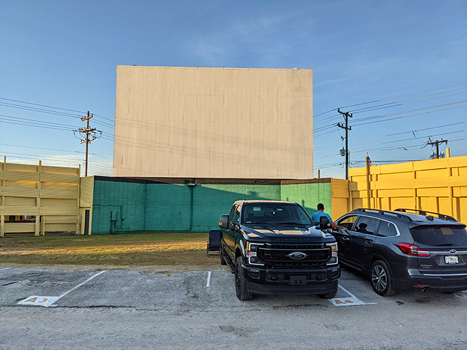 Daytime reveals the impressive scale of the drive-in screen. What looks like a simple white rectangle by day becomes a portal to other worlds after sunset.