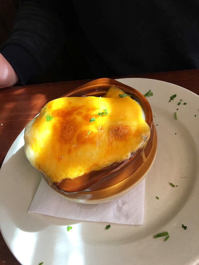 The legendary shepherd's pie arrives in its own rustic crock, that golden-brown potato crust hiding a savory lamb treasure below. This is comfort food royalty.