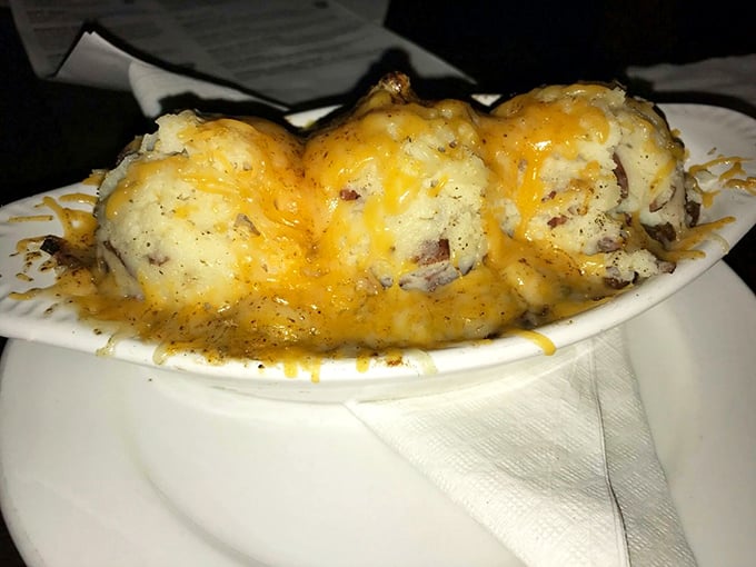 Behold the cheese-crowned glory that locals cross county lines for. These mashed potatoes have achieved what most only dream of—perfect texture and flavor harmony.