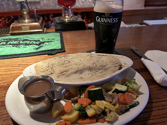 The shepherd's pie arrives like royalty, its golden potato crown protecting a savory kingdom below, with vegetables playing the loyal subjects.