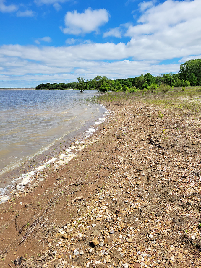 Beach day, Kansas style! The reservoir's shoreline shifts with the seasons, revealing new treasures for beachcombers and fossil hunters alike.