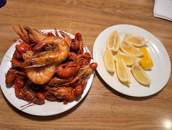 These aren't just shrimp; they're crimson ambassadors from the sea. Paired with lemon wedges that stand ready for duty like tiny yellow soldiers.