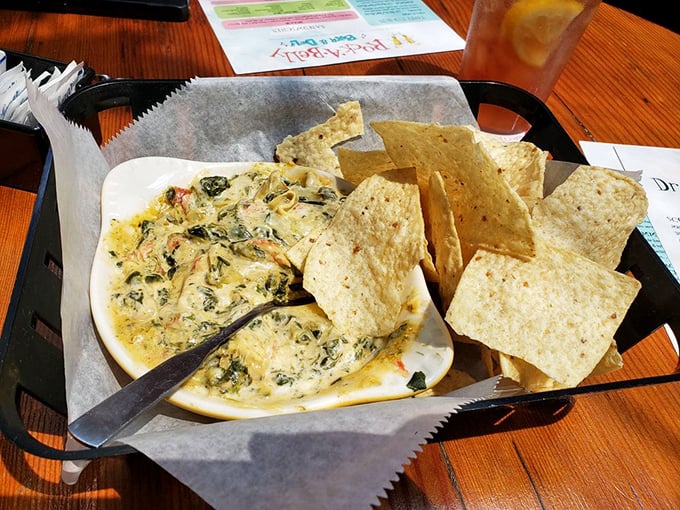 This spinach artichoke dip isn't just served; it's presented&mdash;bubbling hot and creamy, with tortilla chips standing by for their delicious destiny.