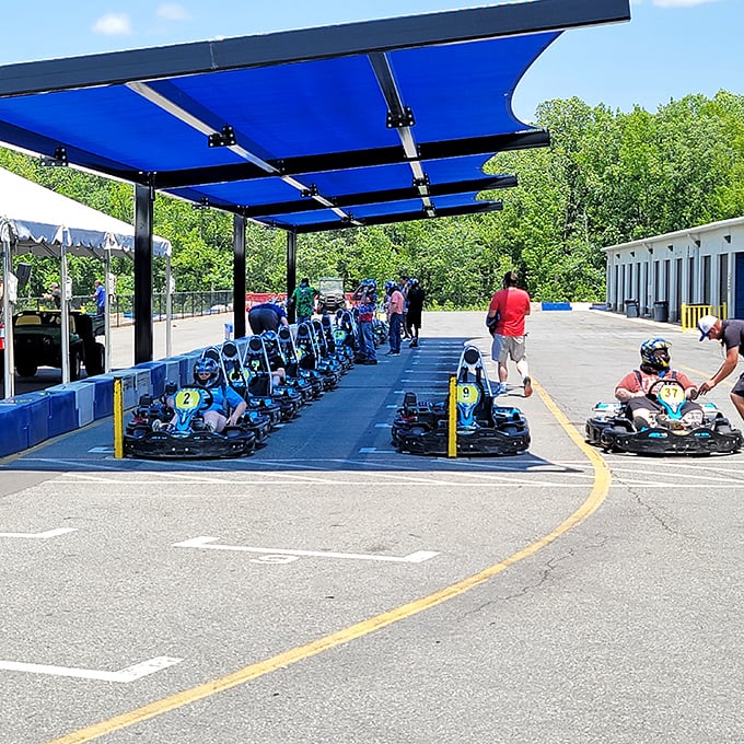 Under blue canopies, drivers prepare for their moment of glory, trading everyday worries for the singular focus of the perfect racing line.
