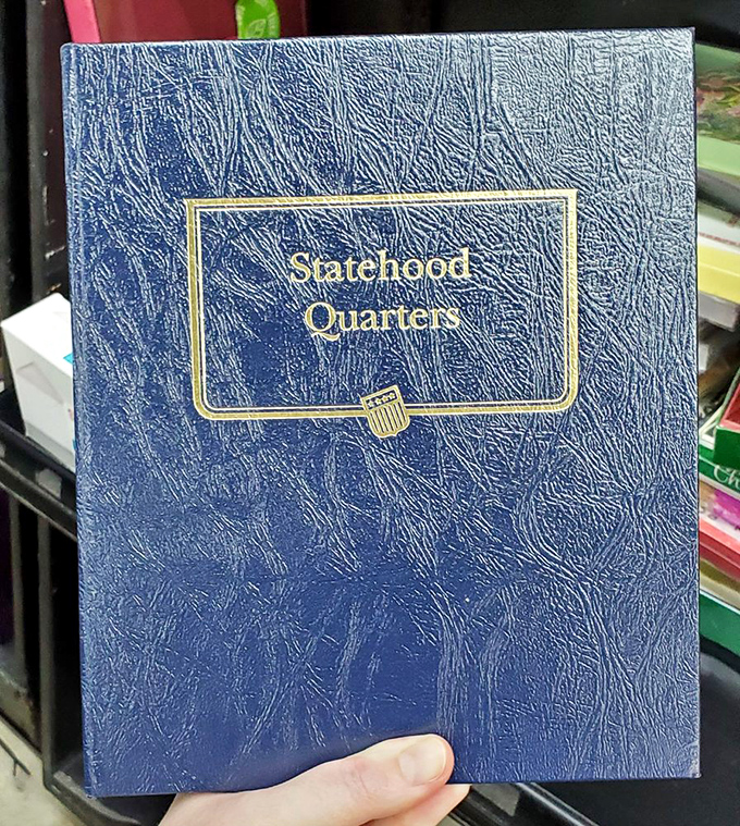 Coin collectors, rejoice! This Statehood Quarters album waits patiently for someone to complete their numismatic journey through America's geography lesson.