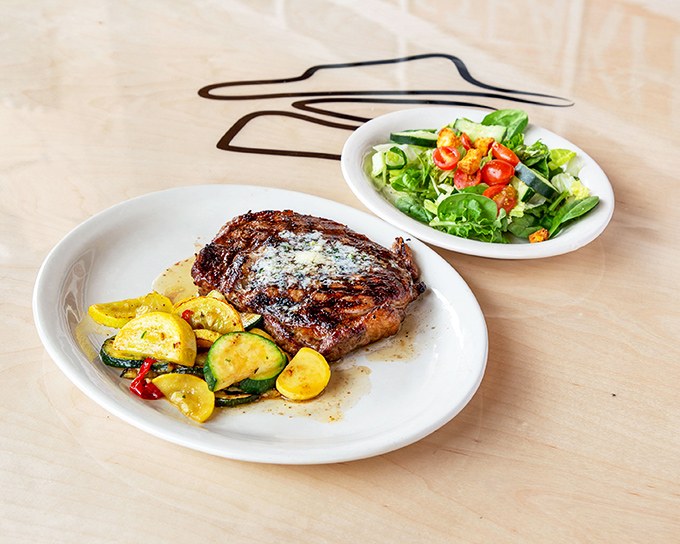 Behold the perfect marriage: a steak with beautiful grill marks beside a salad that doesn't feel like punishment. Balance in the universe is restored.