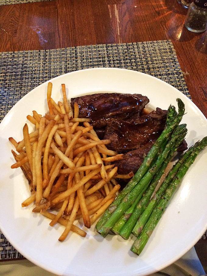 This isn't just dinner&mdash;it's a trilogy of perfection: a perfectly seared steak, golden fries stacked like Jenga pieces, and vibrant asparagus spears for color commentary.