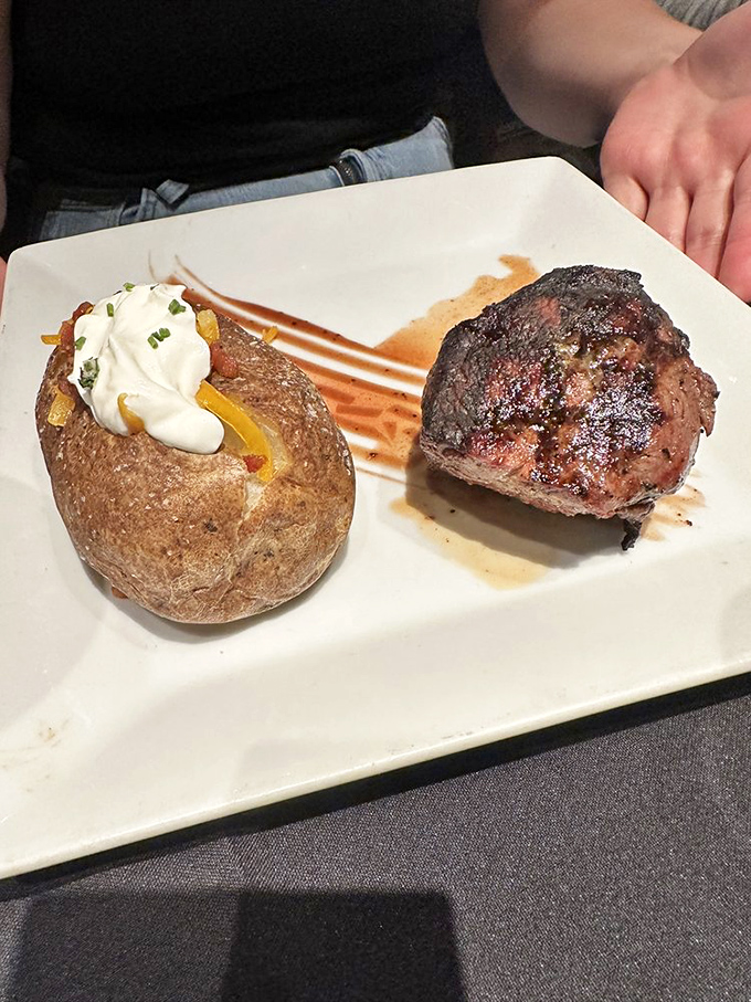 Meat and potato—the Midwest's power couple. This perfectly seared filet and loaded baked potato have been happily married on plates across Kansas for generations.