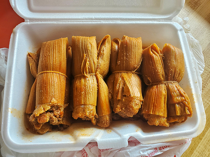 Behold the stars of the show: tamales bundled like precious cargo, their corn husks barely containing the spiced perfection within.