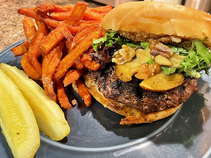 A burger masterpiece that would make Michelangelo weep, paired with sweet potato fries that could start their own fan club.