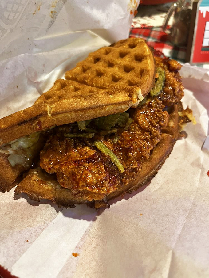 The Ragin' Cajun doesn't just satisfy hunger—it conquers it. Crispy fried chicken nestled between golden waffles like a savory-sweet hug.