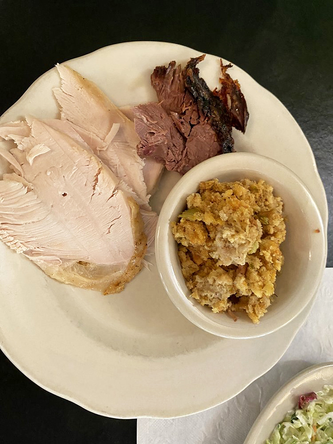Turkey sliced so perfectly it could win a geometry contest, paired with cornbread stuffing that would make your grandmother secretly take notes.