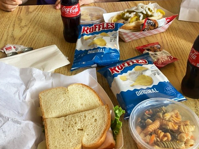 Simple pleasures done right—a classic sandwich paired with Ruffles chips and a Coke creates a lunch symphony that Mozart himself would have appreciated.
