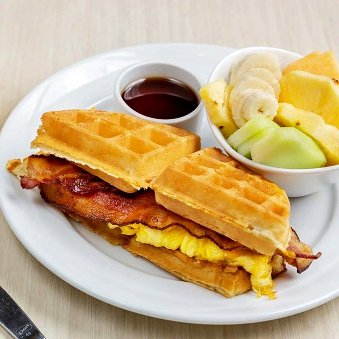 Breakfast sandwich architecture at its finest&mdash;golden waffles embracing eggs and bacon with the kind of harmony that makes morning people of us all.