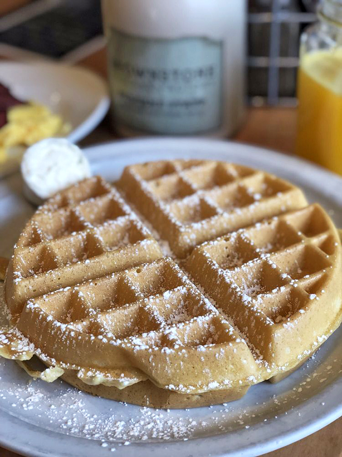 Perfection has a grid pattern. This golden Belgian waffle, dusted with powdered sugar, proves sometimes the classics need no improvement&mdash;just pure maple syrup.