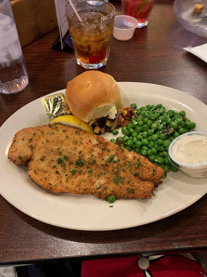 This fish doesn't just look good dressed up – it tastes like it was swimming this morning, served with fresh vegetables and a roll worthy of sopping up every last bite.