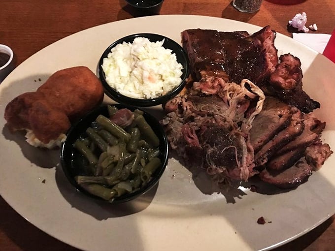 This isn't just a plate; it's a barbecue geography lesson featuring pulled pork, ribs, green beans, and potatoes that would make a vegetarian reconsider.