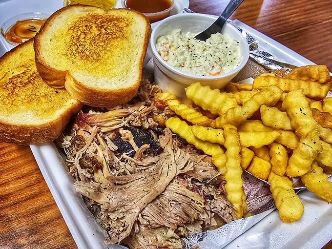 Pulled pork that practically melts on contact, golden crinkle-cut fries, and coleslaw that actually complements rather than competes with the star attraction.
