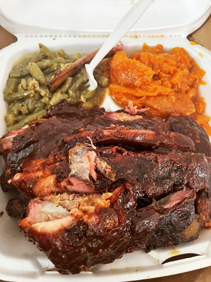 Behold the star of the show: ribs with that perfect smoke ring, nestled beside mac and cheese that would make your grandmother question her recipe. 