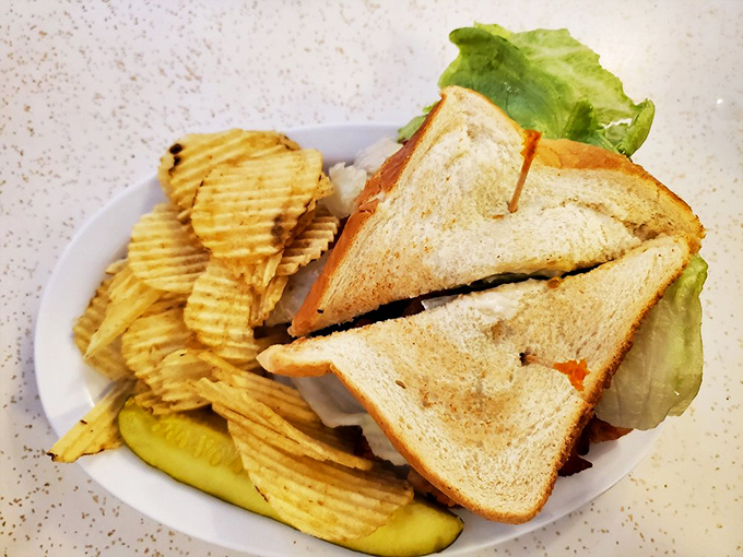 Not just any sandwich&mdash;a proper Midwestern lunch with ridged chips and a pickle spear. Simple pleasures in a world gone fancy.