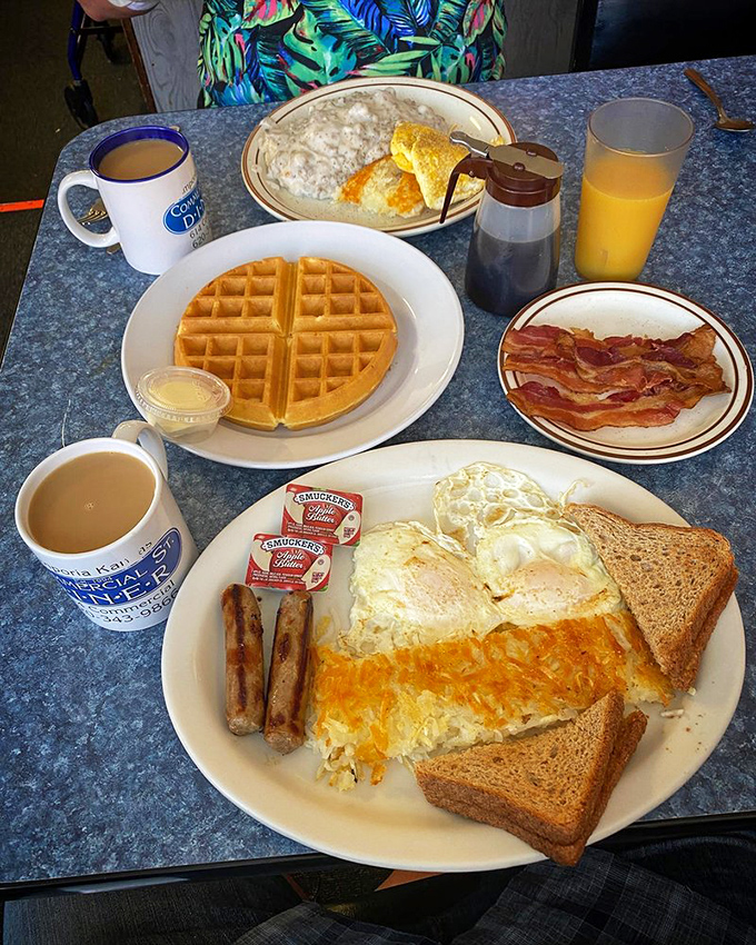 Breakfast symphony in four movements: golden waffle, crispy bacon, perfect eggs, and that coffee mug that never seems to empty.