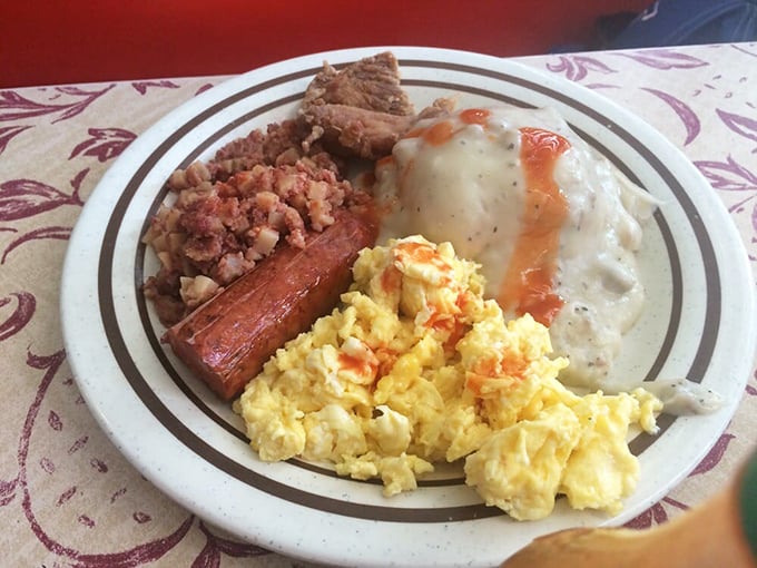 Breakfast nirvana on a plate: scrambled eggs with just the right fluff, a strip of bacon with perfect bend, and creamy gravy that could make cardboard taste good.