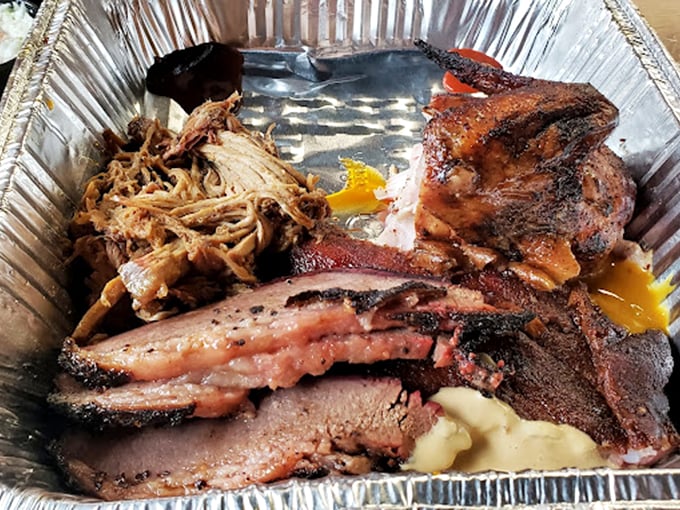 Brisket, pulled pork, and ribs sharing one container? It's like the holy trinity of barbecue decided to throw a party in a tin box.
