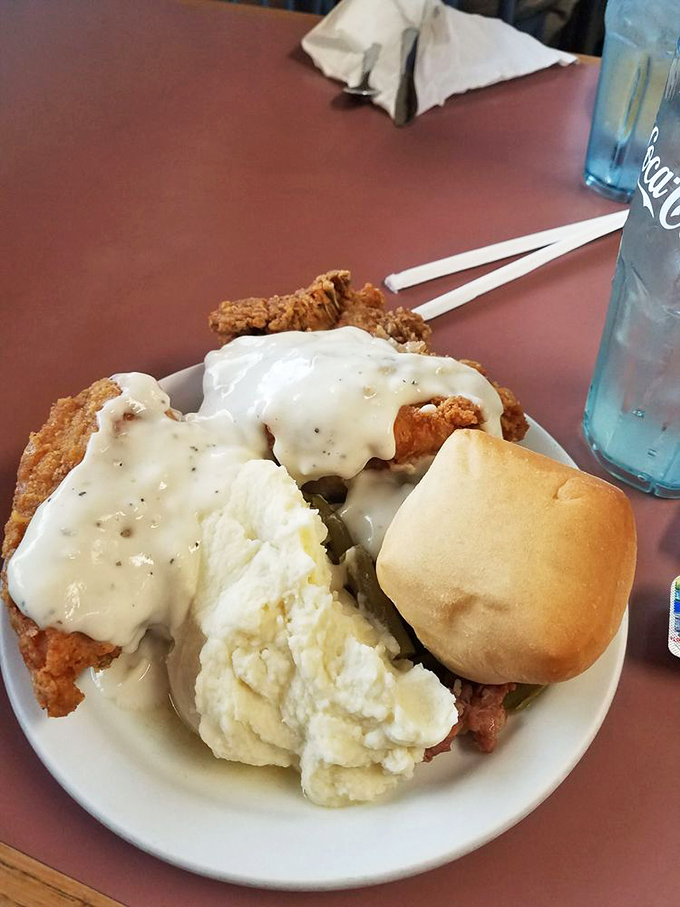 Country-fried heaven on a plate! Crispy chicken, creamy mashed potatoes, and that gravy that could make cardboard taste like a gourmet experience.