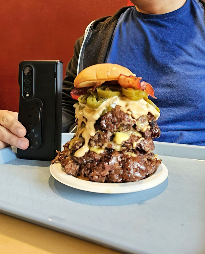 Not so much a burger as a skyscraper of beef&mdash;this towering triple needs its own zip code and possibly structural support beams.