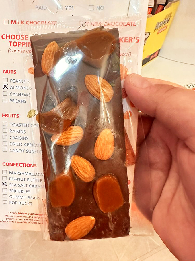 This custom chocolate bar isn't just dessert, it's architecture&mdash;almonds and caramel creating a skyline of flavor worth savoring.