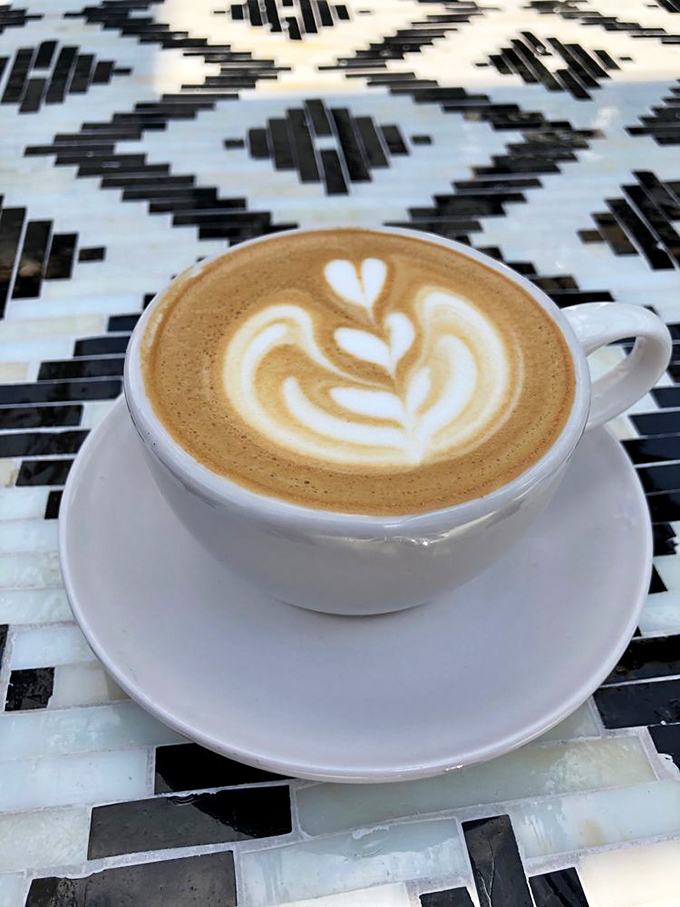 Latte art so pretty you almost don't want to drink it. Almost. That leaf design is practically begging you to ruin its perfection. 