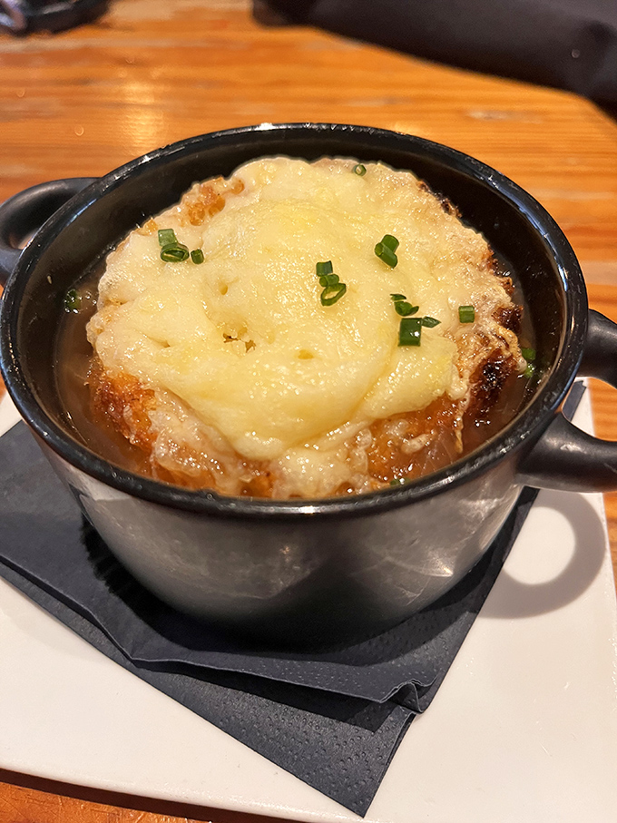 This isn't just French onion soup—it's a bubbling cauldron of cheese-capped bliss that makes you question all other soups you've ever known.