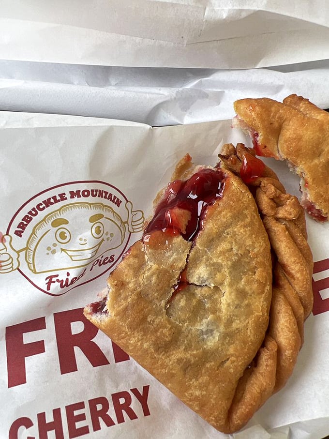 Cherry filling escaping its golden prison&mdash;the telltale sign of a properly stuffed pie. Resistance is futile, napkins are essential.