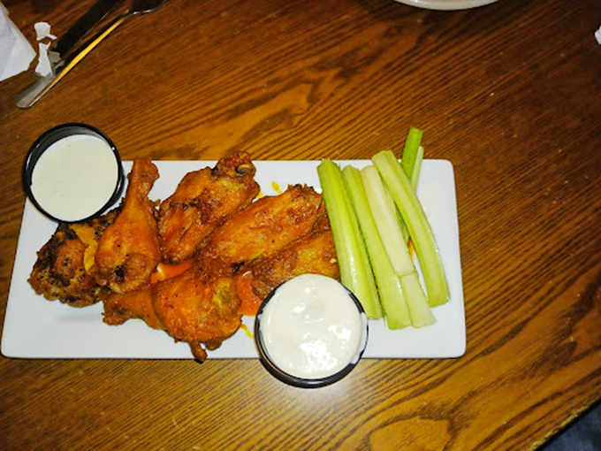 These wings aren't just served; they're presented with ceremony&mdash;crispy, saucy ambassadors flanked by cooling celery and creamy dipping companions.