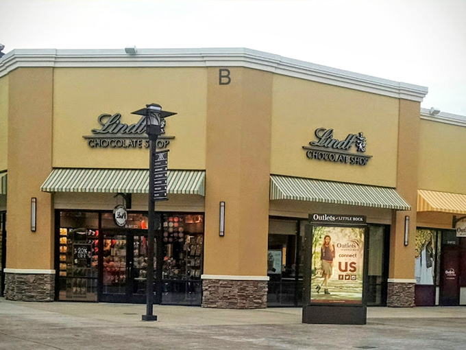 The Lindt Chocolate Shop stands as a sweet oasis amid the sea of fashion retailers—proof that not all outlet treasures come with sleeves.