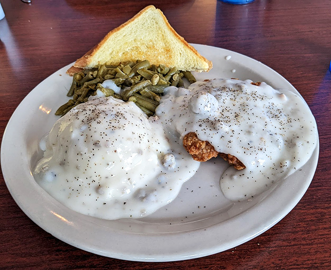 Behold the holy grail of comfort food: country fried steak smothered in pepper gravy so good it should have its own fan club and Instagram account.
