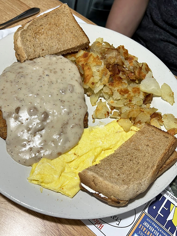 Country fried steak smothered in peppery gravy alongside crispy home fries and fluffy eggs&mdash;the breakfast trinity that makes morning people out of night owls.