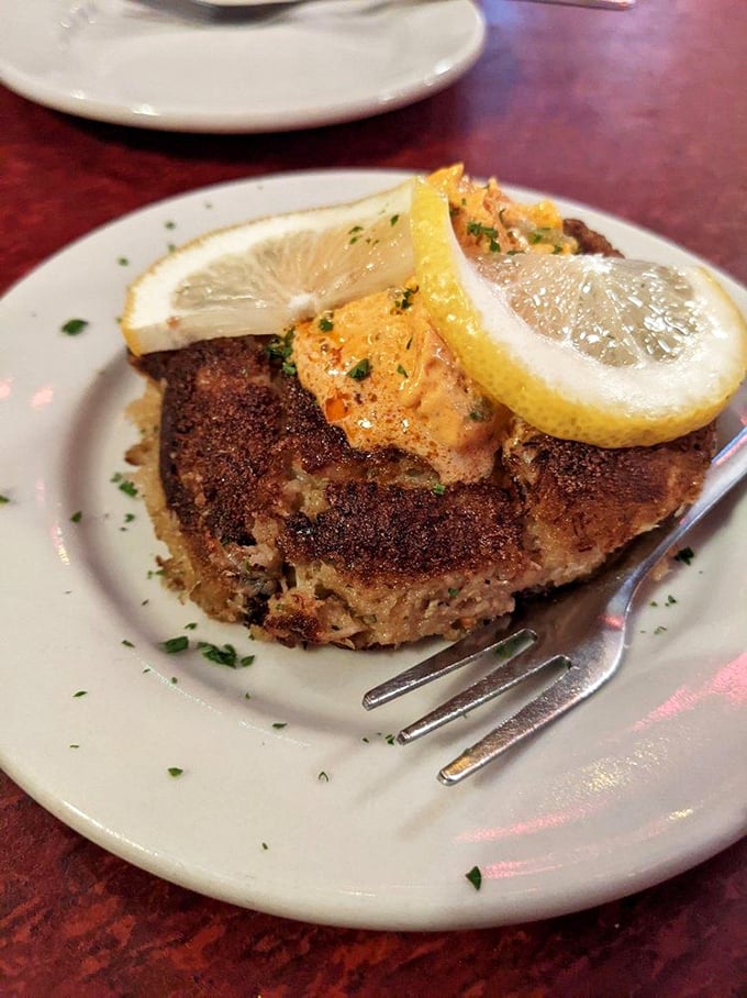 The legendary crab cake arrives like a golden disc of happiness, topped with a bright lemon slice that says, "Yes, we're in Indiana, but we know seafood."