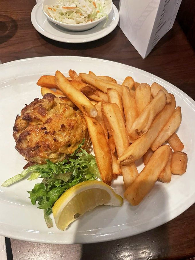 Golden-brown perfection meets French fry abundance. This crab cake doesn't just sit on the plate&mdash;it commands attention like a delicious diva.