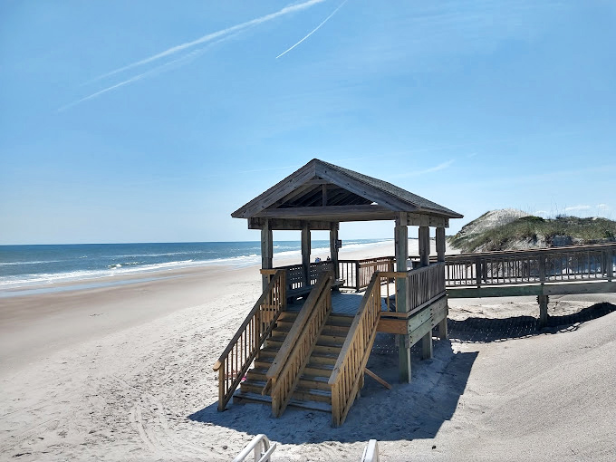 Beach access pavilions &ndash; where architecture meets necessity. Like a perfect appetizer, they're just enough structure before the main course of nature.